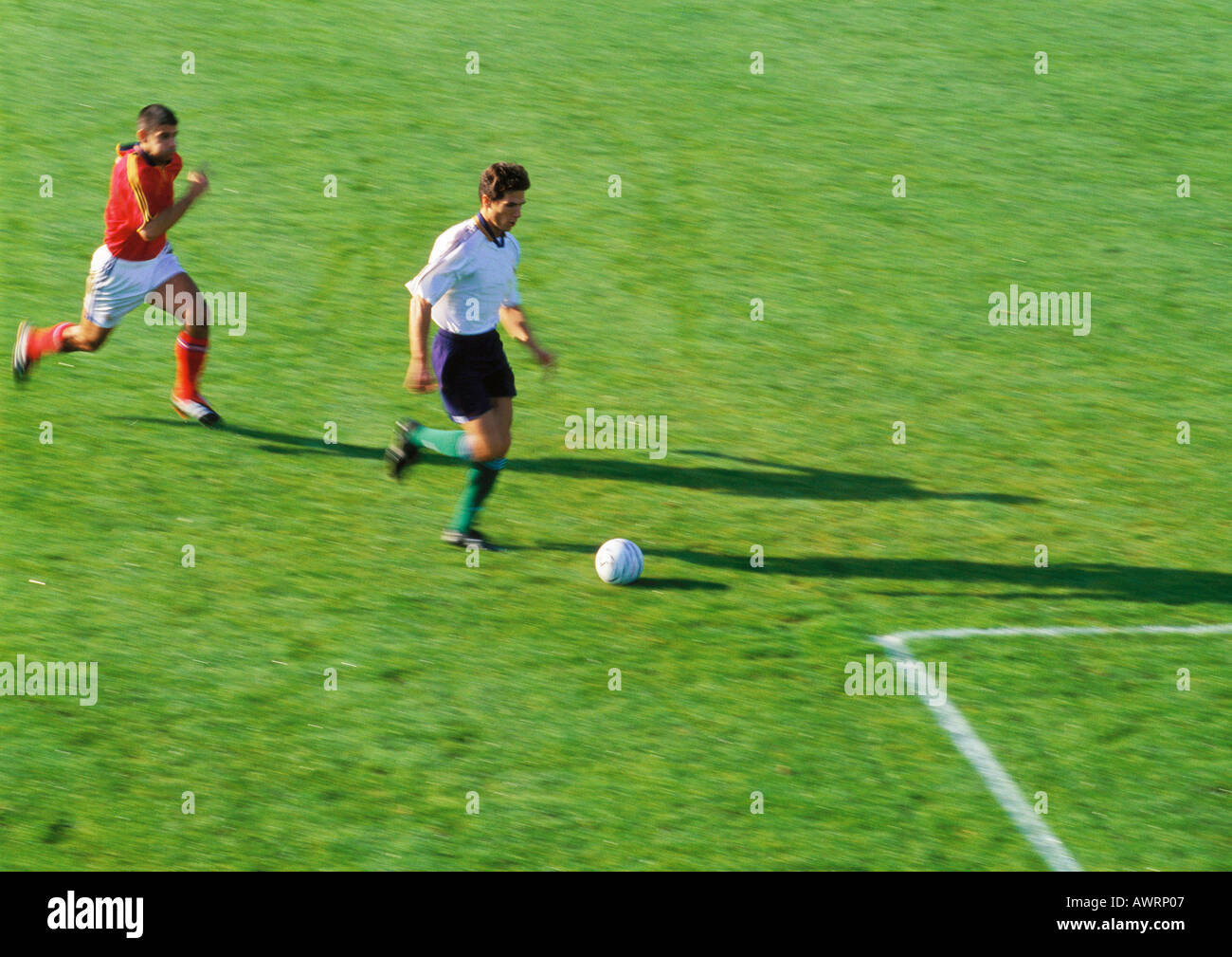 Two soccer players running for ball Stock Photo - Alamy