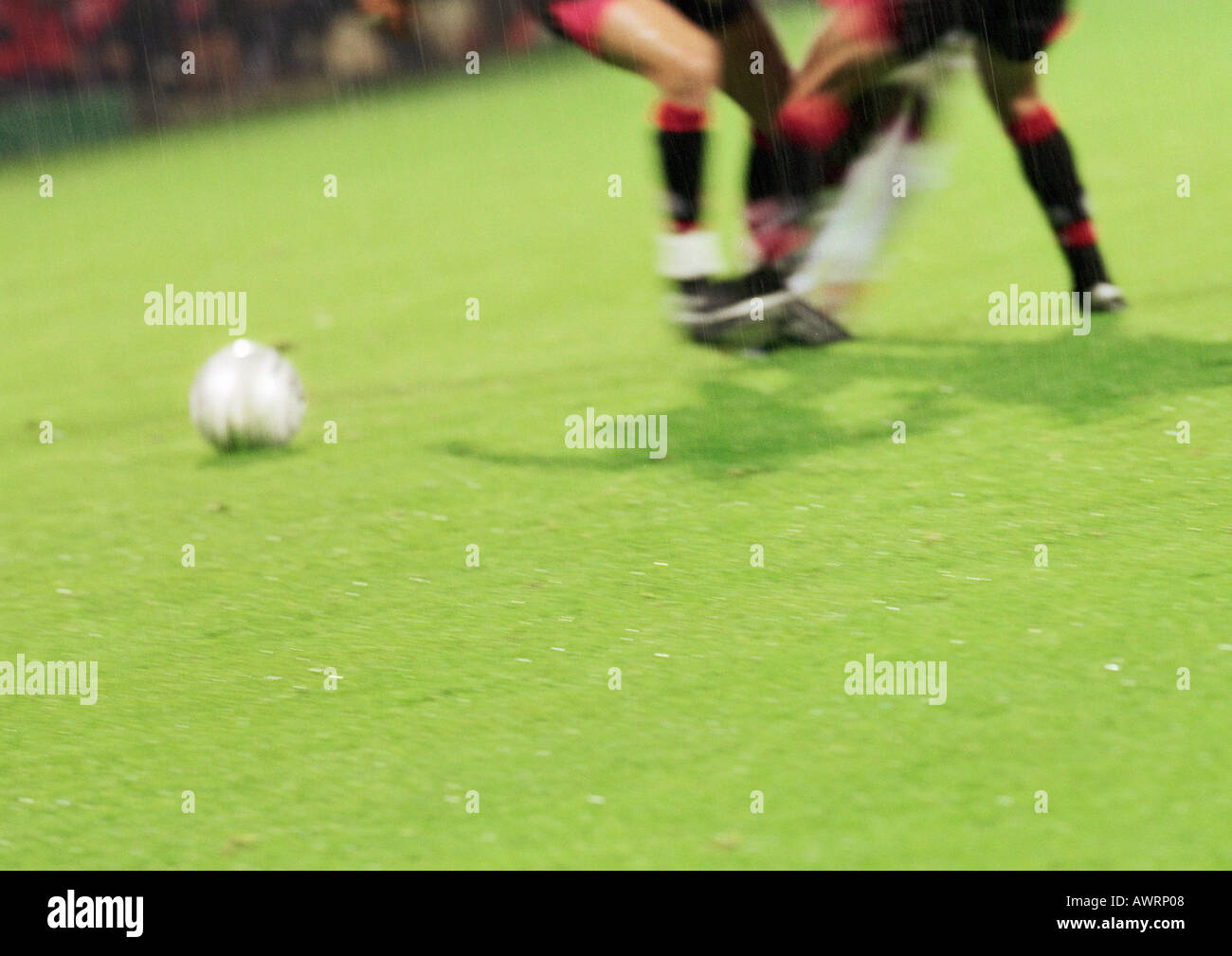 Two soccer players running for ball, blurred, low section Stock Photo ...