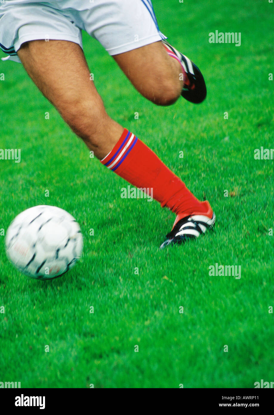 Soccer player's legs, running with ball, low section Stock Photo - Alamy