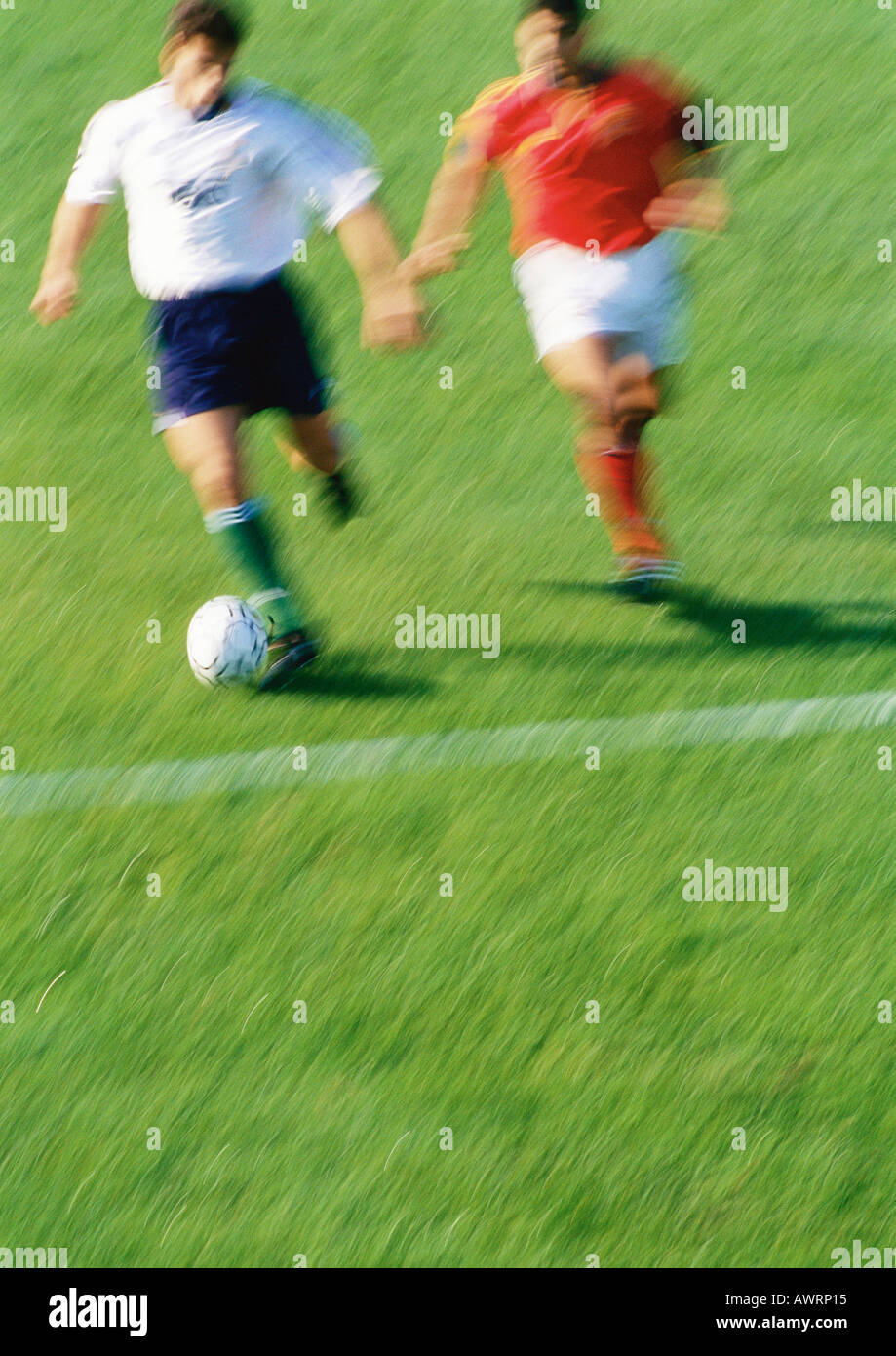 Soccer player running with ball, opponent chasing him, blurred Stock ...