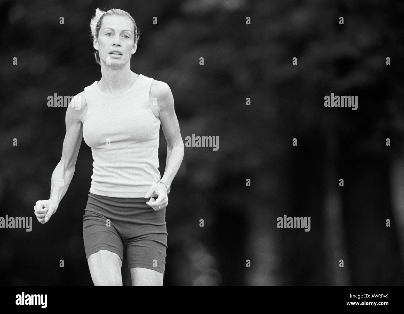 Woman in sports clothes running, three quarter length, b&w Stock Photo ...
