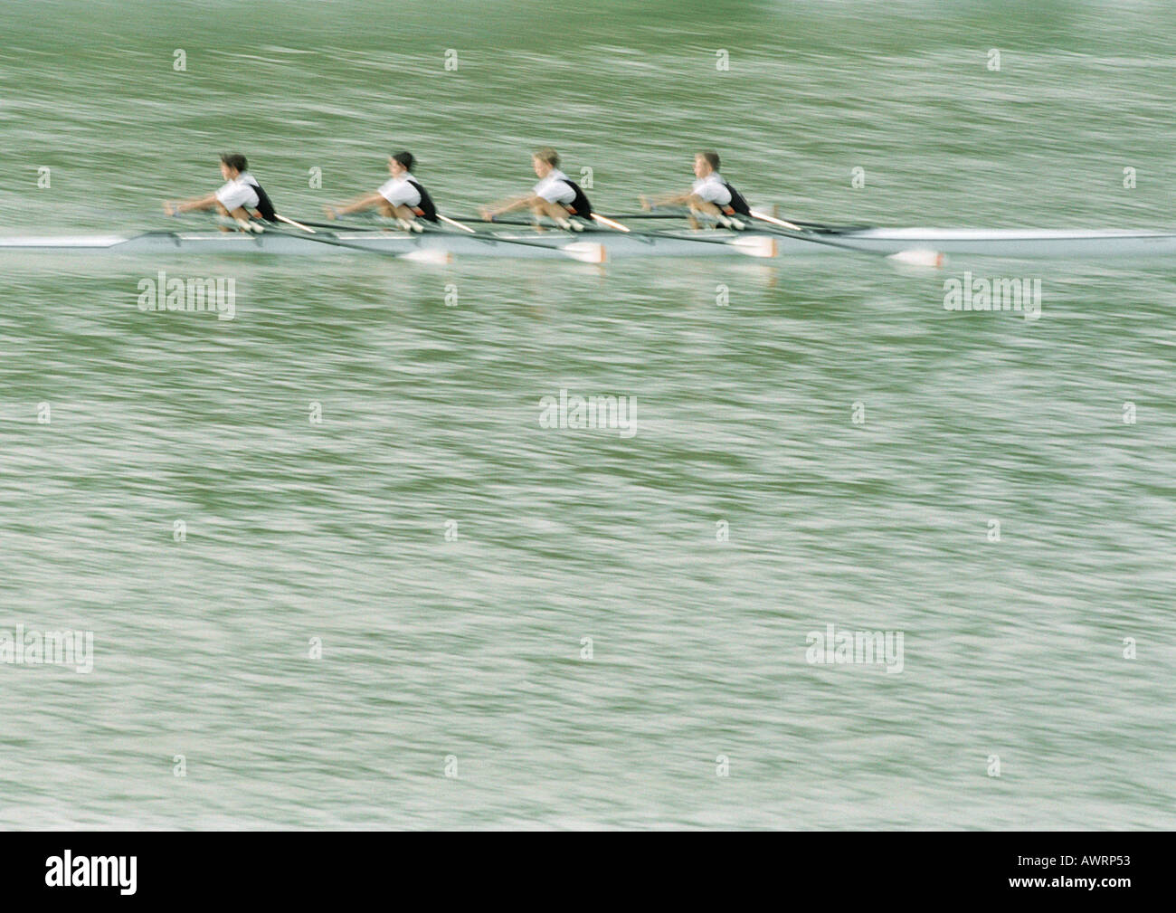 Four teenage boys rowing crew in boat, side view Stock Photo - Alamy