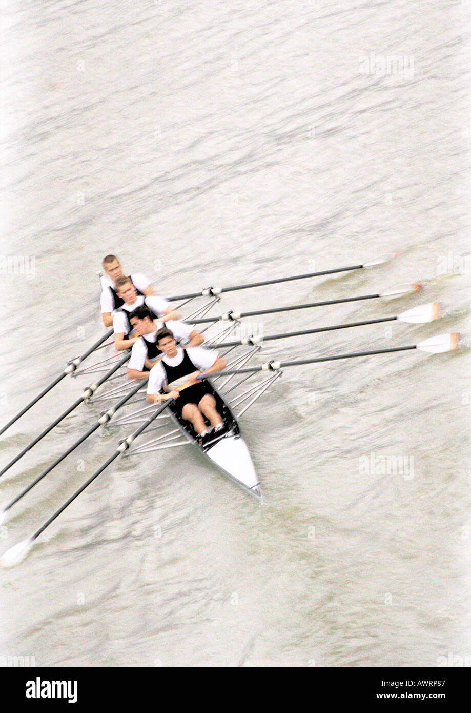 Four teenage boys rowing crew in boat, elevated view Stock Photo - Alamy