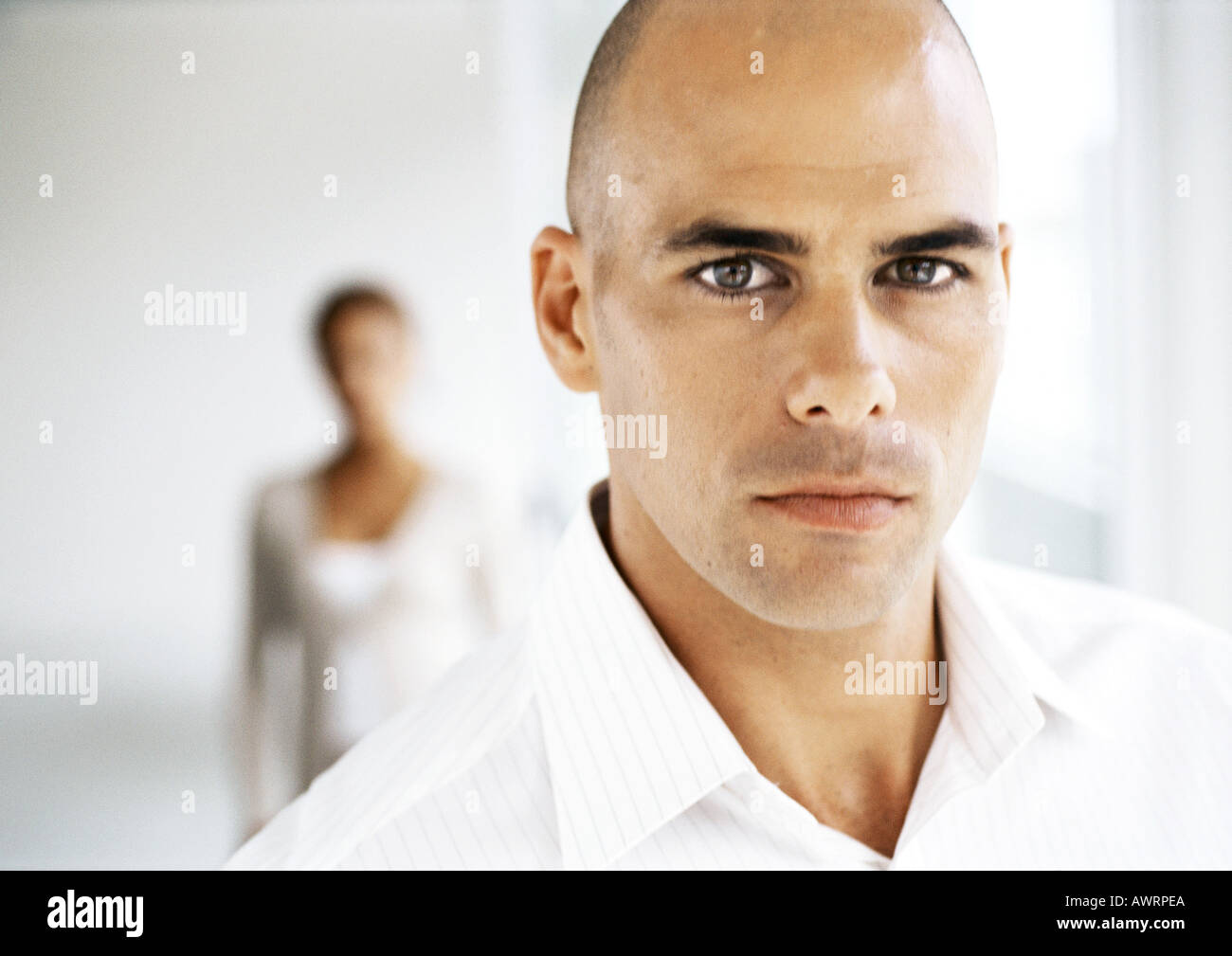 Two serious looking men view two portraits hi-res stock photography and ...