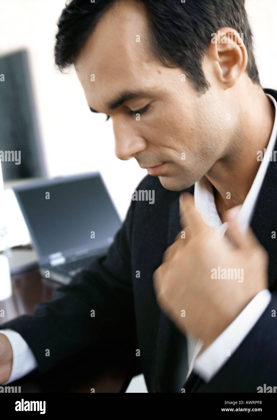 Businessman looking down, side view Stock Photo - Alamy