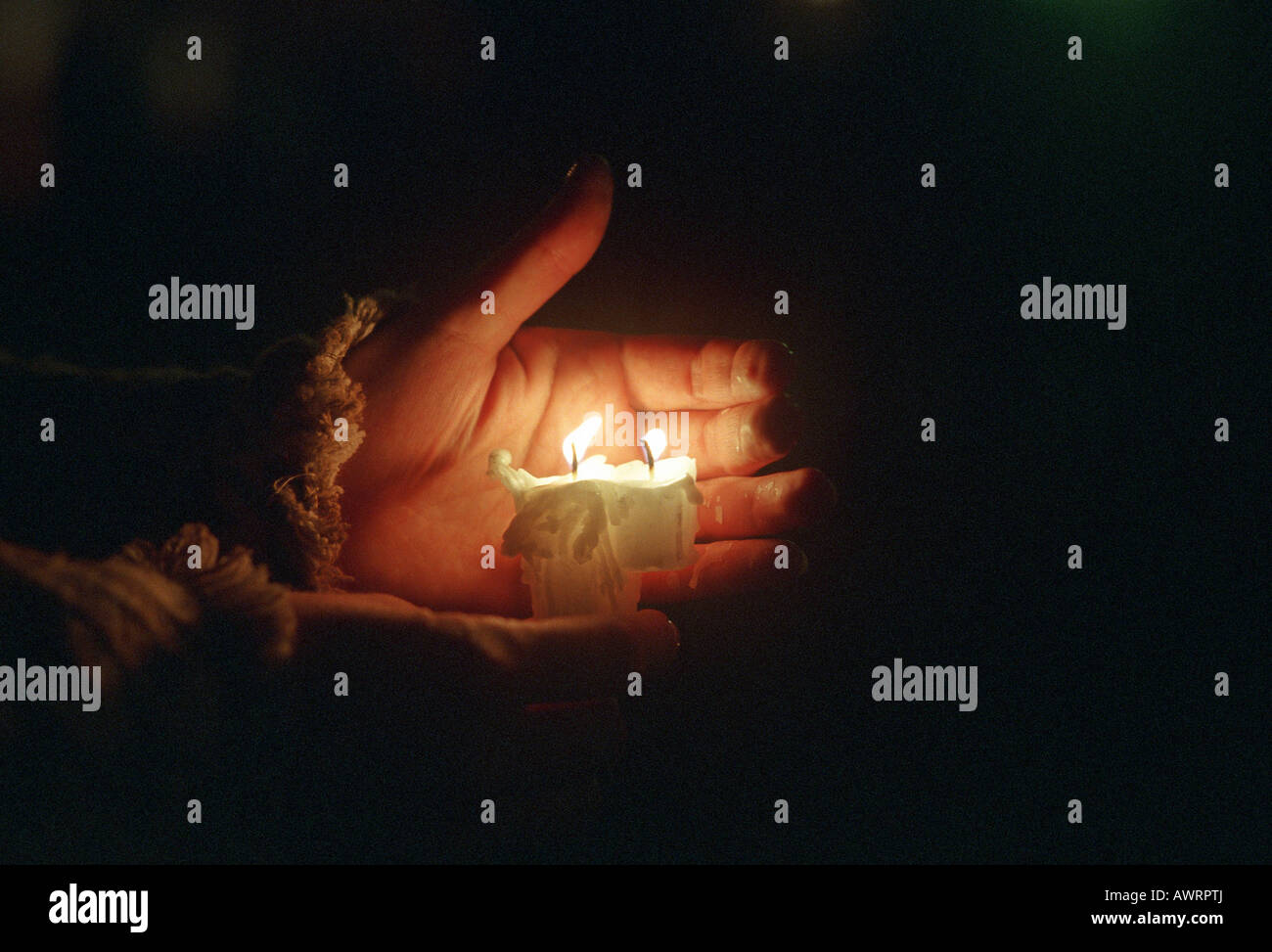 Hand holding a burning candle at a divine service for the deceased Pope ...