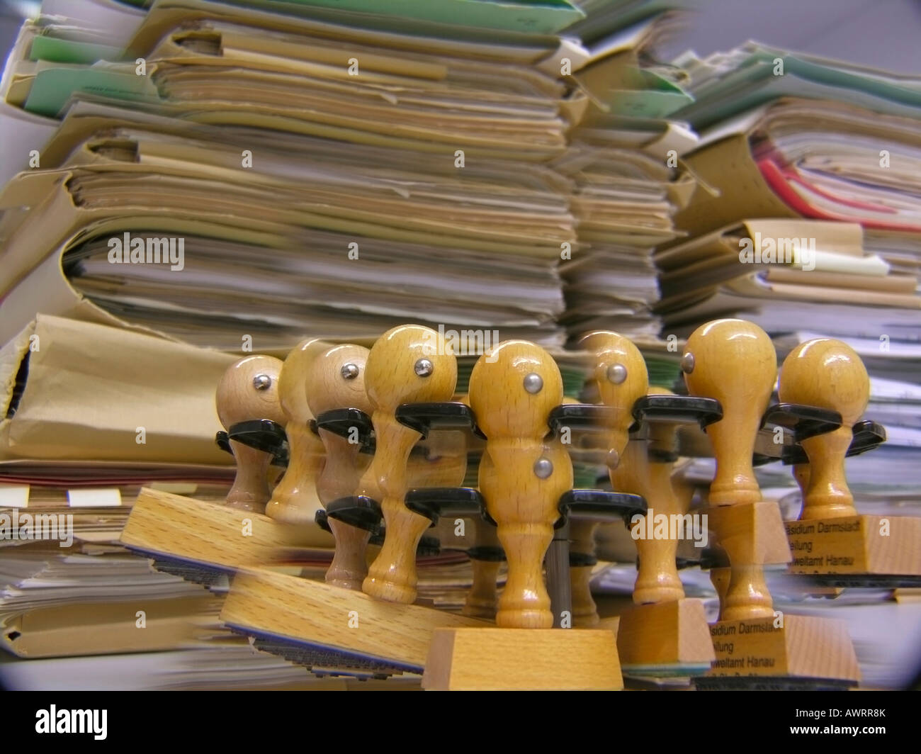 desk with stamps and lots of files folders and documents working in ...