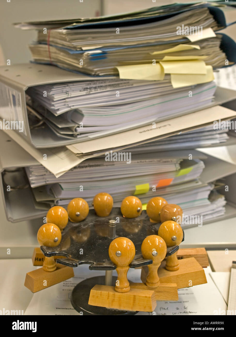 desk with stamps and lots of files folders and documents working in ...