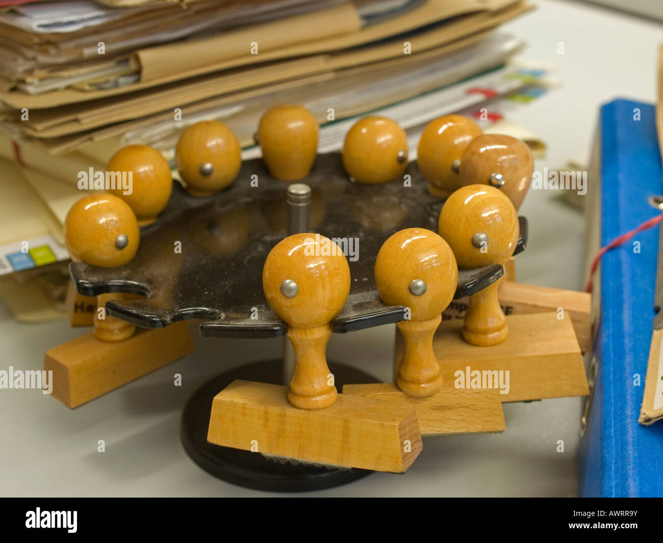 desk with stamps and lots of files folders and documents working in ...
