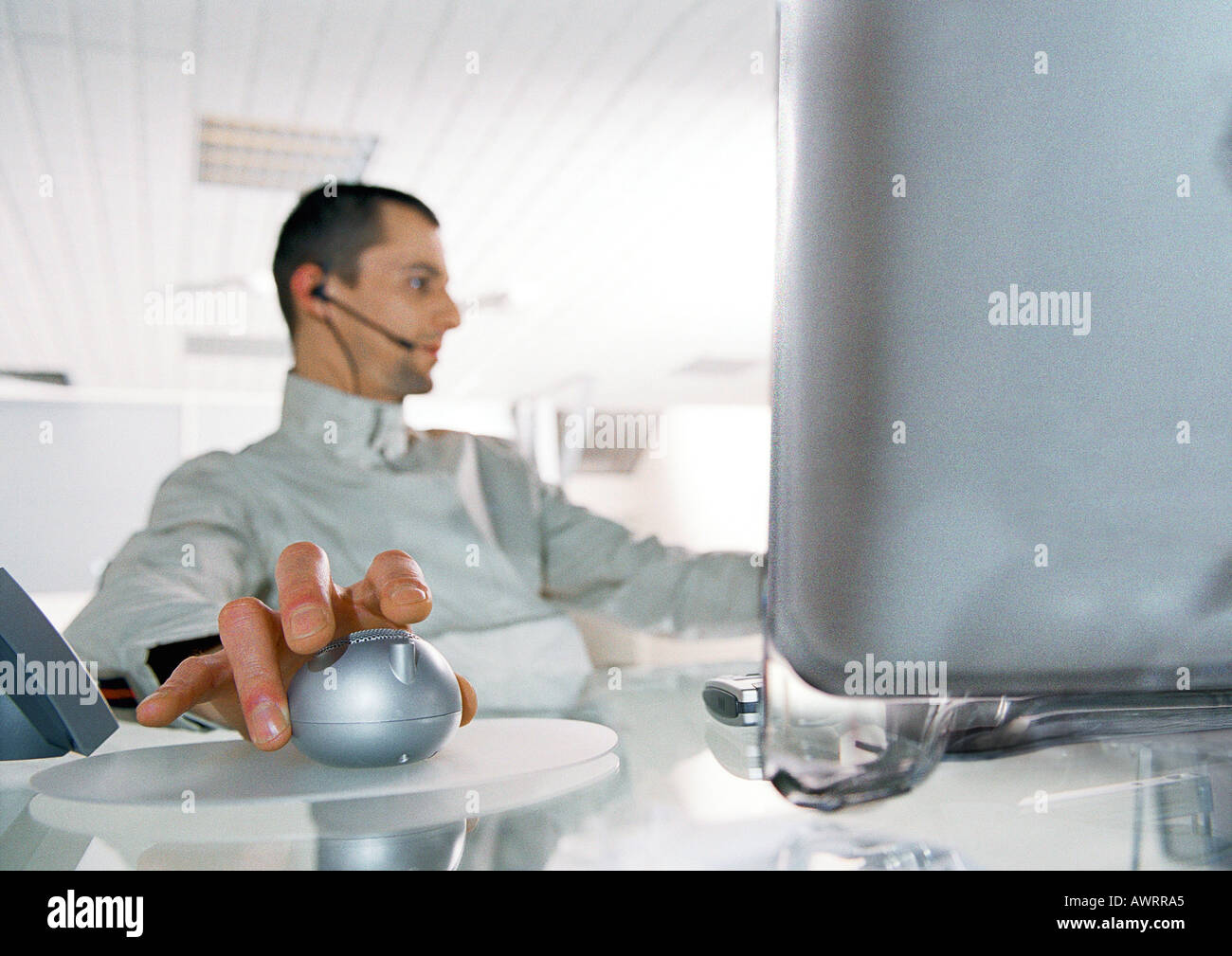 Man at desk using cordless mouse Stock Photo - Alamy