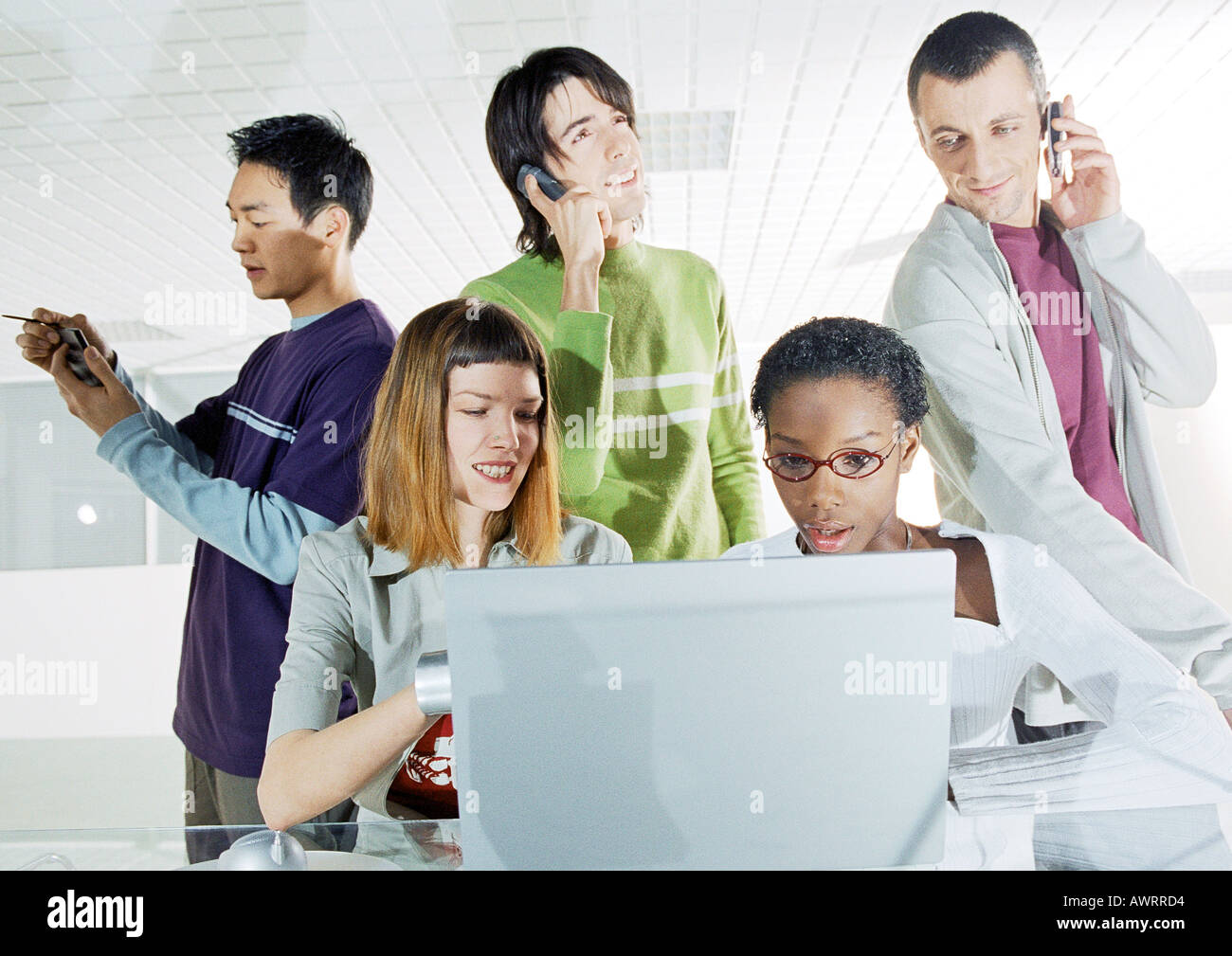 Group of people gathered around computer Stock Photo - Alamy
