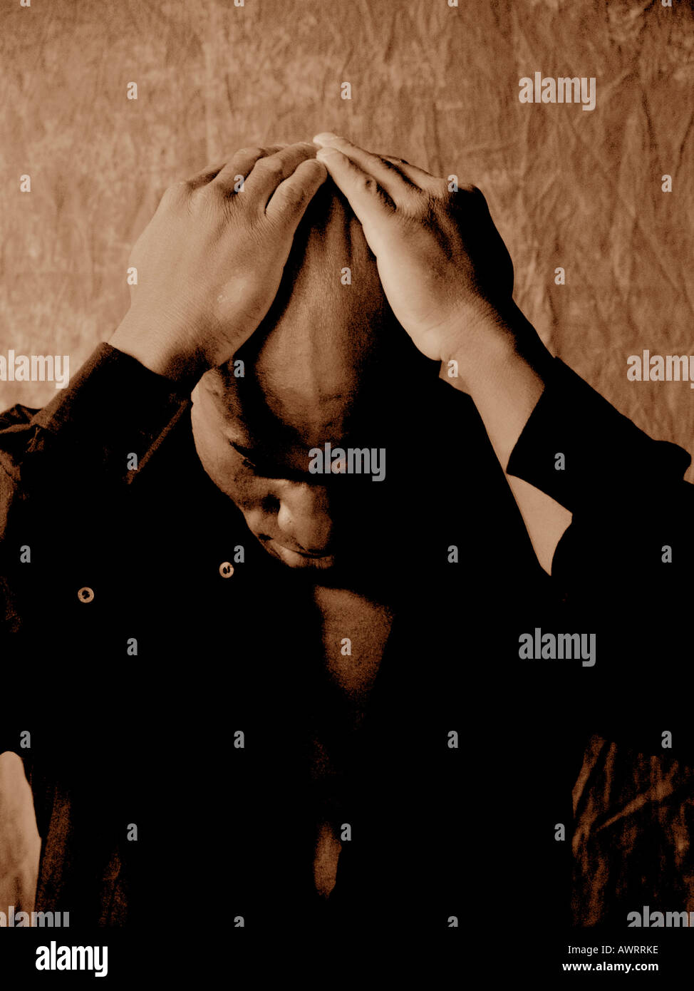 A black man covers his head with his hands Stock Photo - Alamy