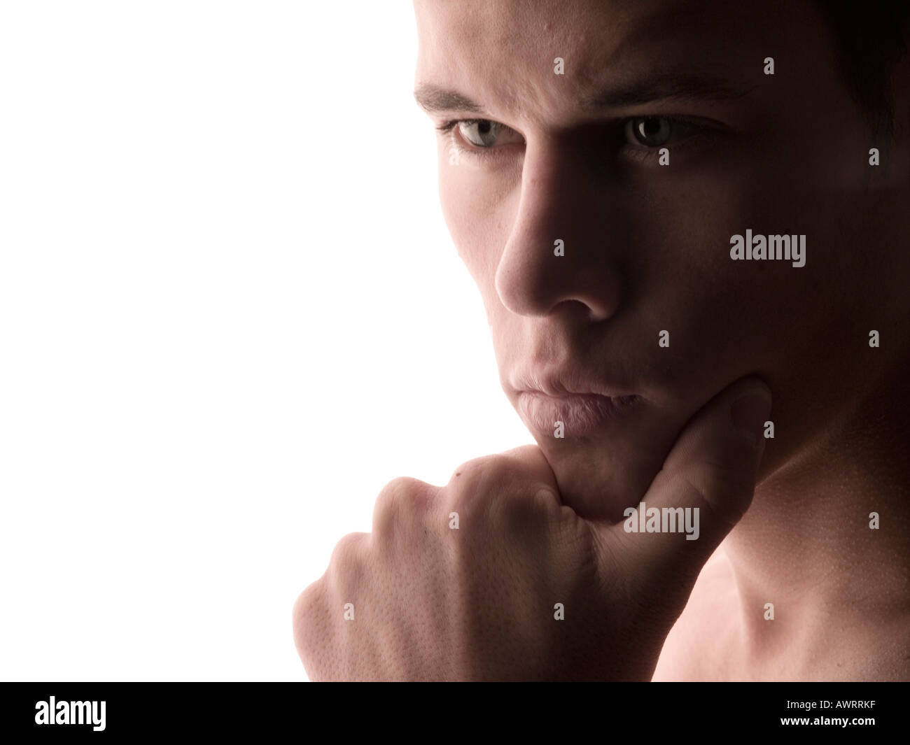 Close-up of the face of a serious young man Stock Photo - Alamy