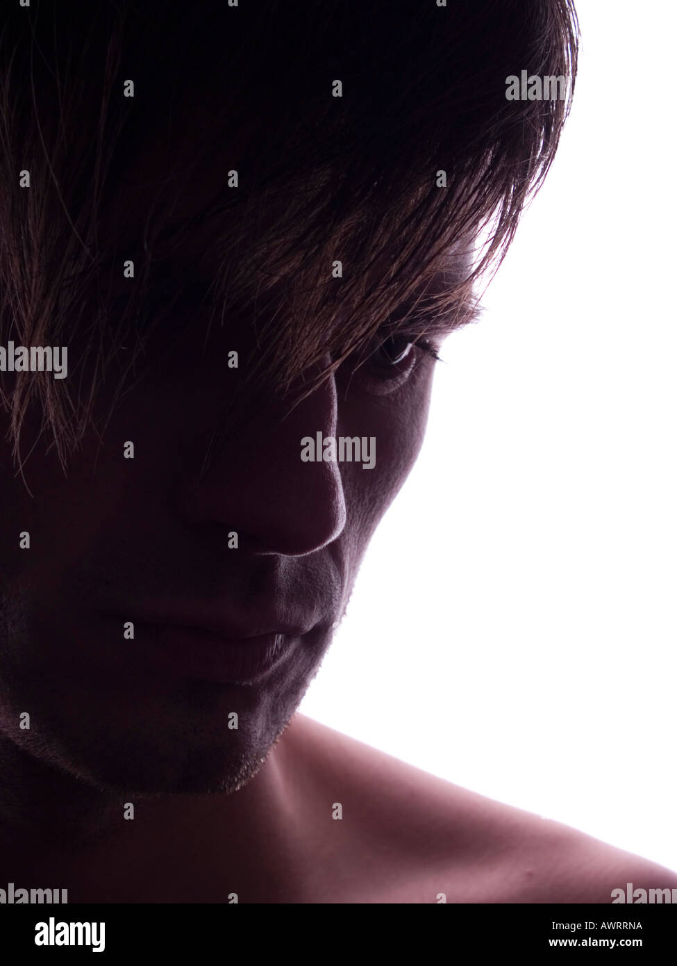 Close-up of the face of a serious young man in backlight Stock Photo ...