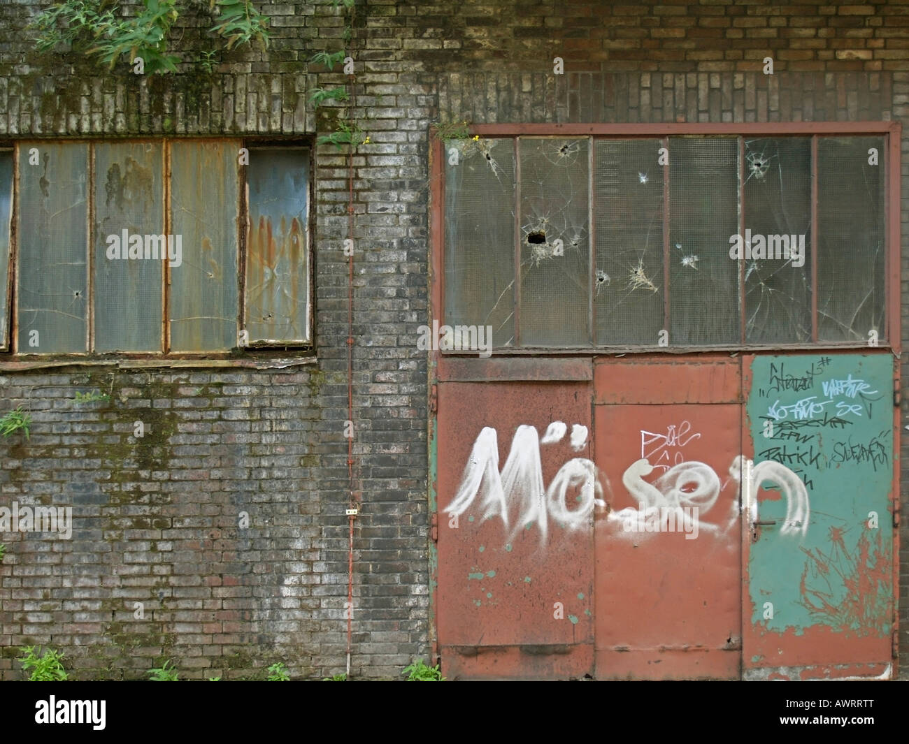 old decayed building garage with scribbling daub graffiti on a wall ...