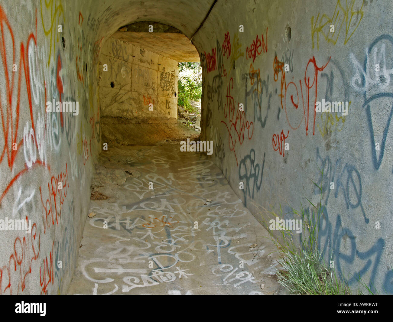 long empty passage tunnel with graffiti on concrete wall Stock Photo ...