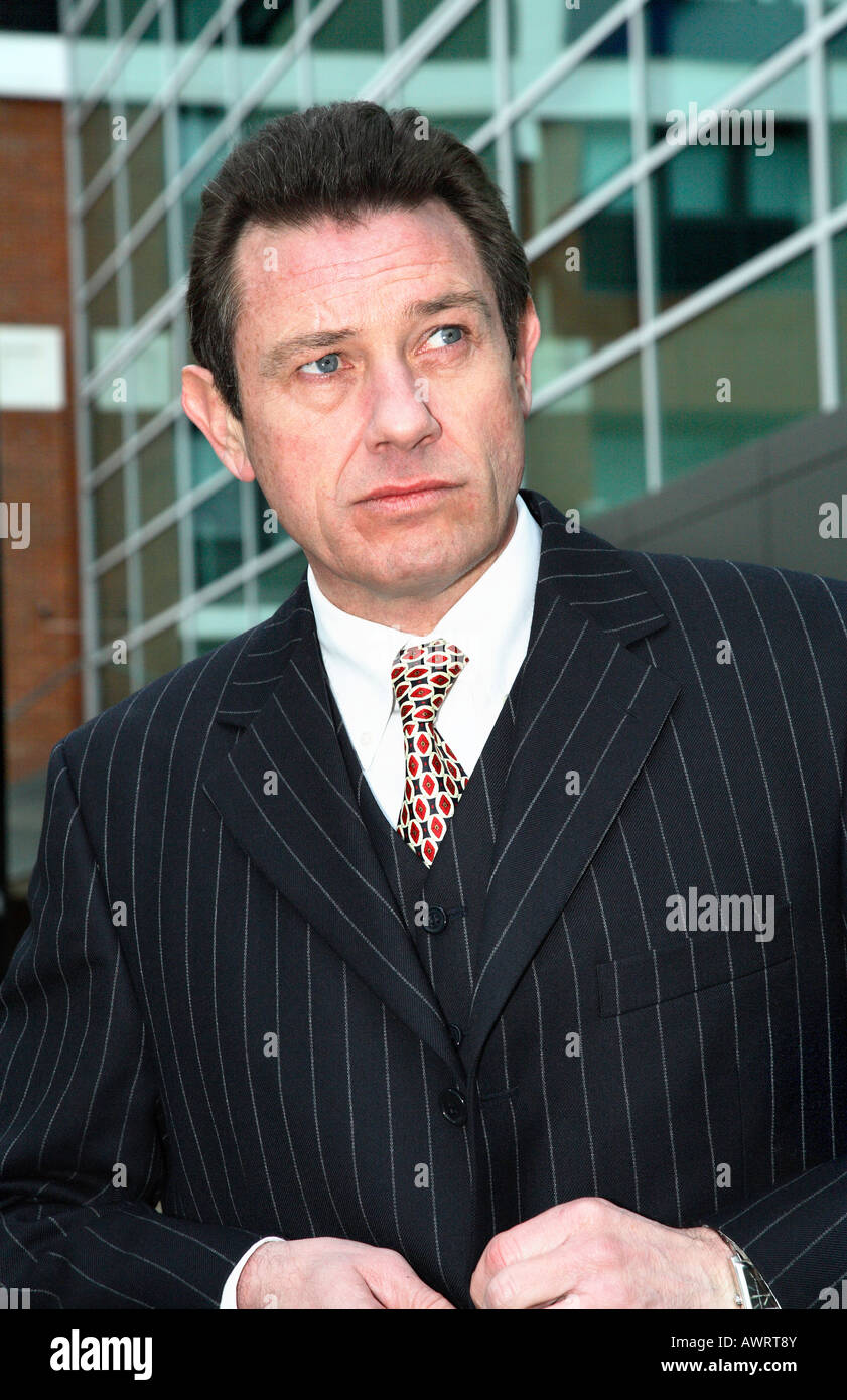 Serious male executive outside office block Stock Photo - Alamy