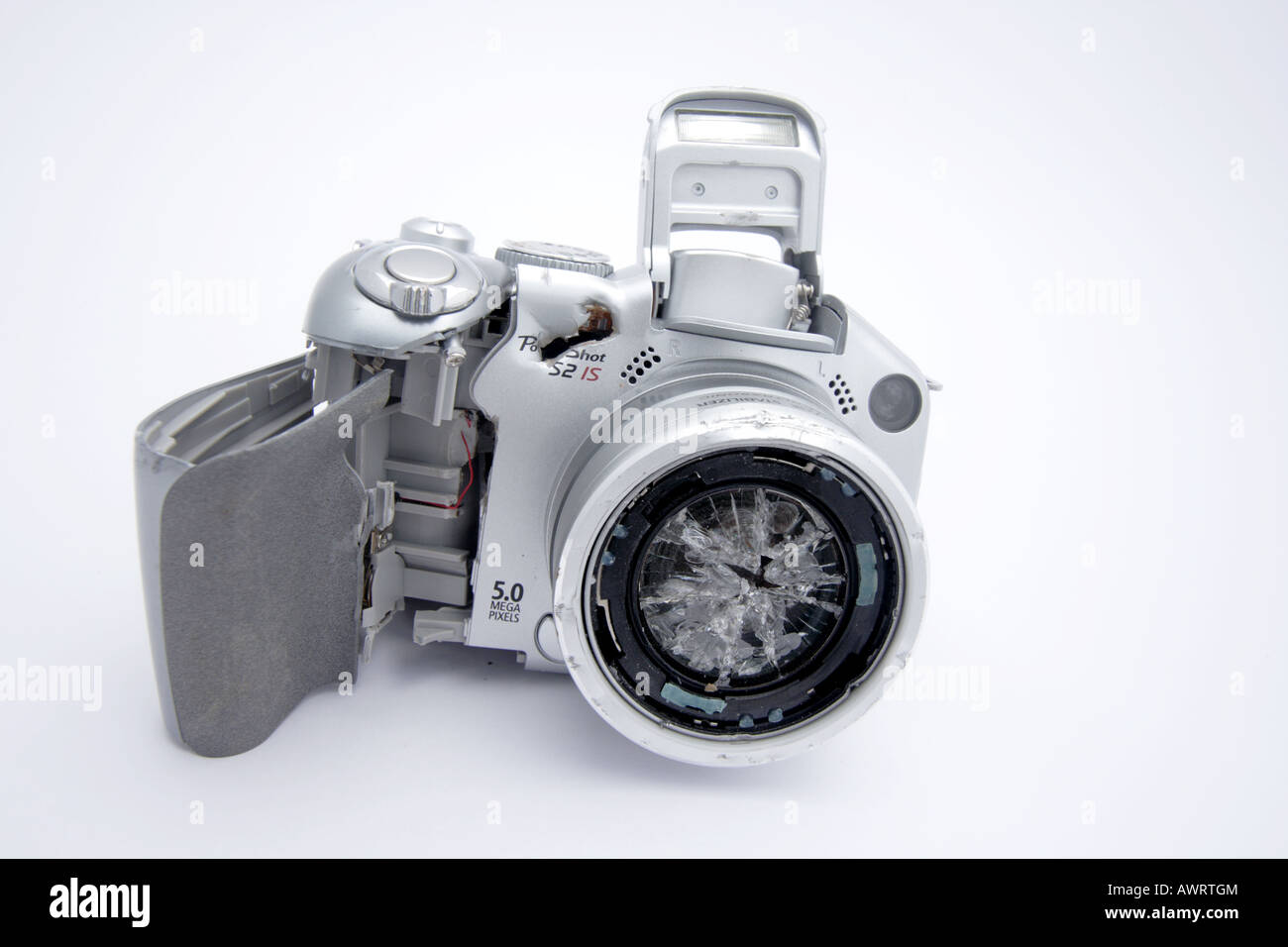 A SEVERLY DAMAGED DIGITAL CAMERA WHITE BACKGROUND HORIZONTAL BDB11532 ...
