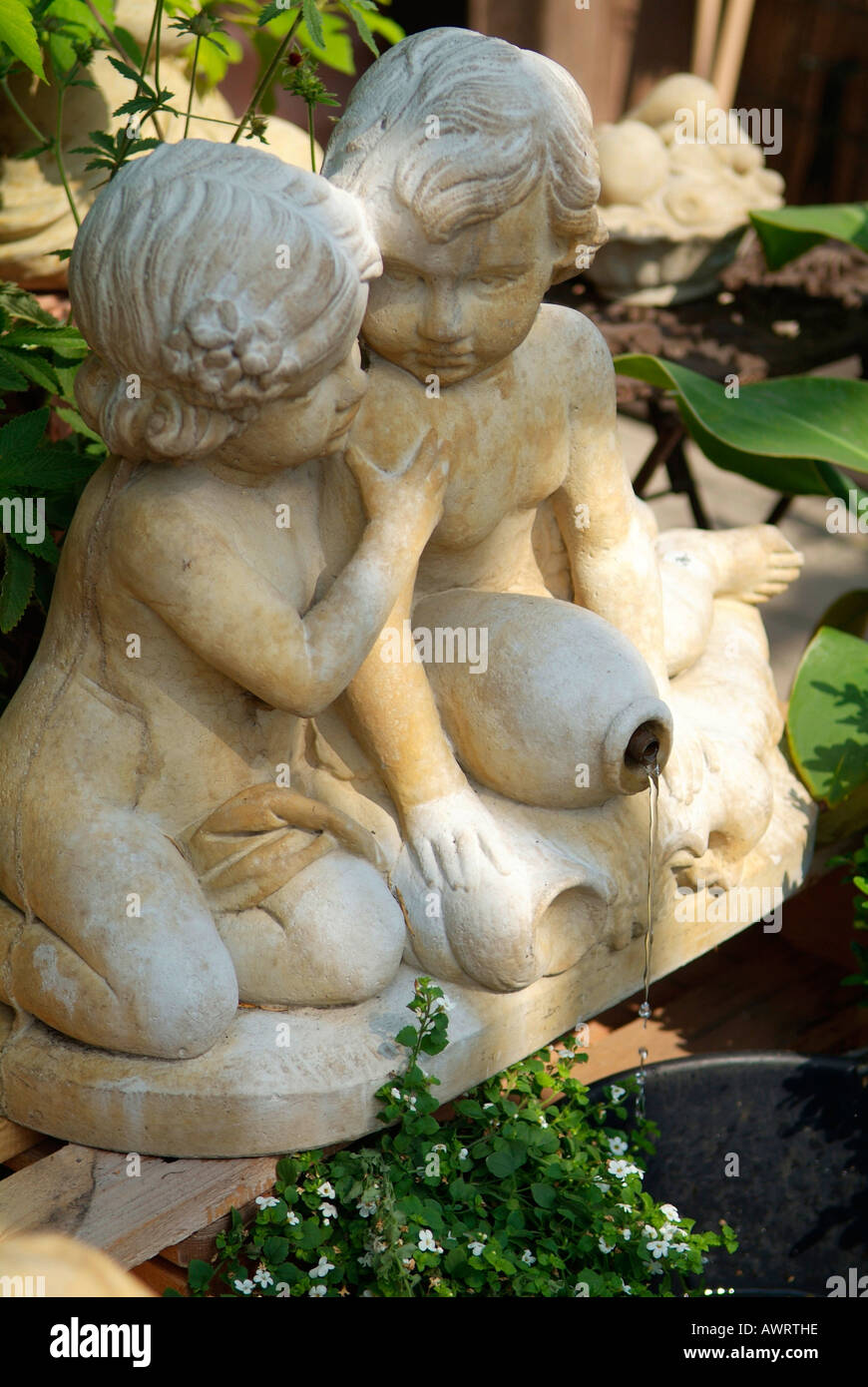 Fountain, two putti as decoration in the garden Stock Photo - Alamy