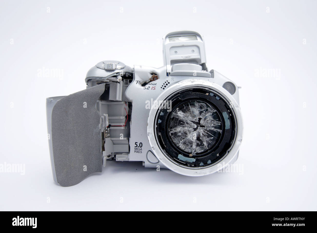 A SEVERLY DAMAGED DIGITAL CAMERA WHITE BACKGROUND HORIZONTAL BDB11533 ...