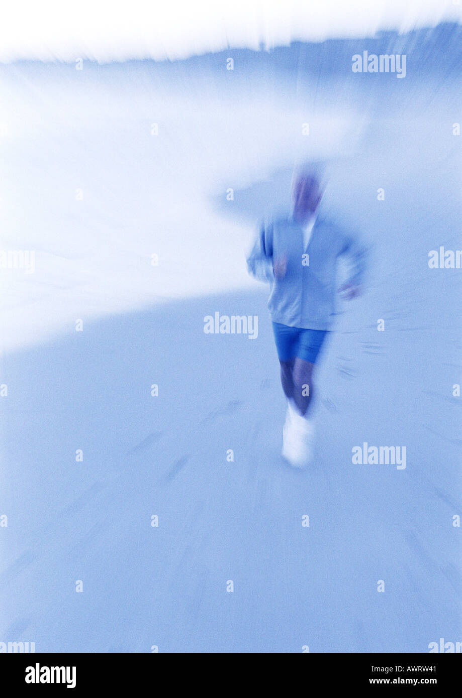 Mature man running on beach, blurred Stock Photo - Alamy