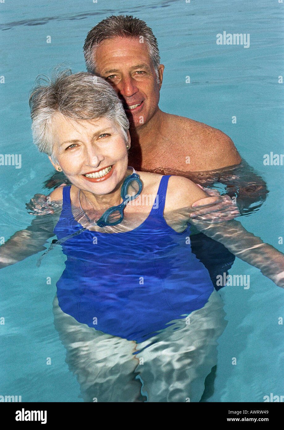 Mature couple in swimming pool, smiling, portrait Stock Photo - Alamy