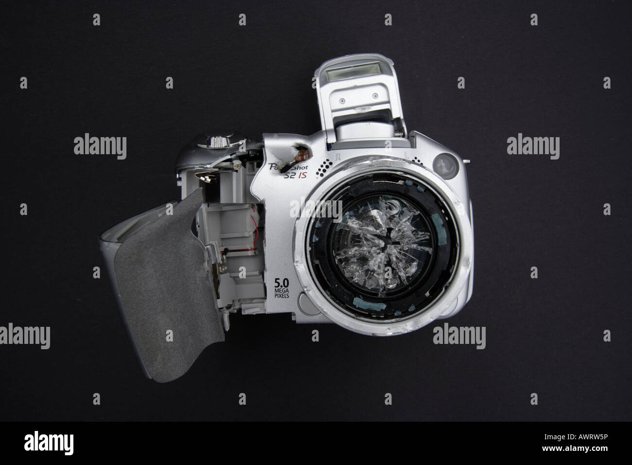 A SEVERLY DAMAGED DIGITAL CAMERA BLACK BACKGROUND HORIZONTAL BDB11534 ...