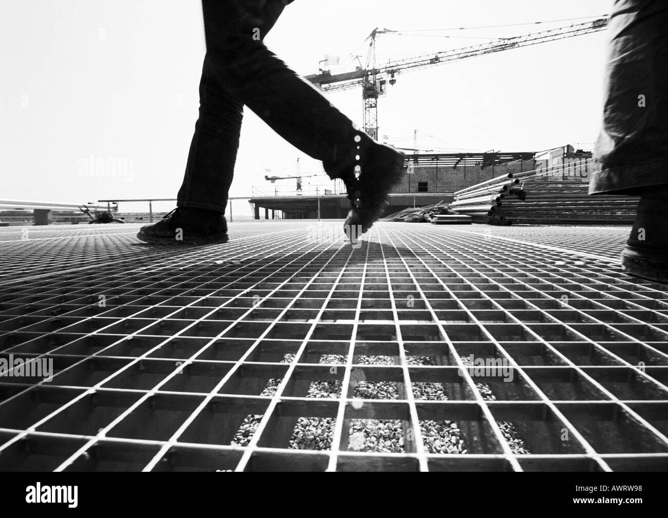 Person walking on construction site, low section Stock Photo - Alamy
