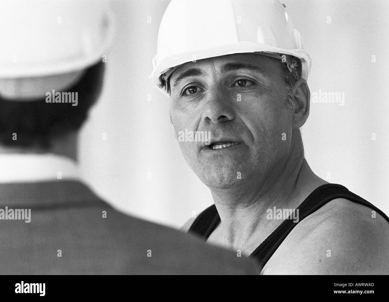 Builders wearing hard hats, close-up, b&w Stock Photo - Alamy