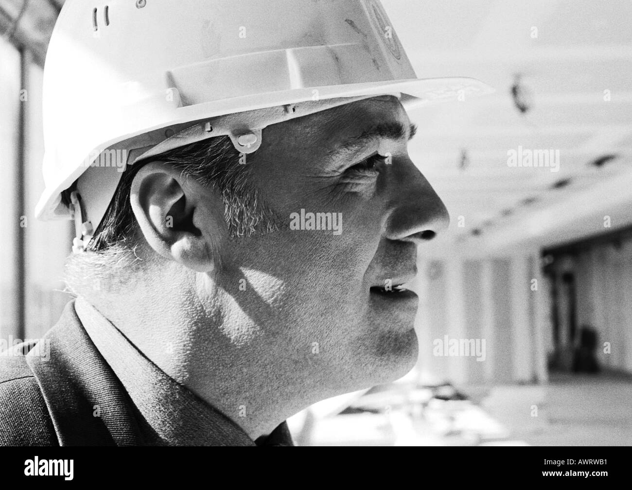 Man wearing hard hat, side view, close-up, b&w Stock Photo - Alamy