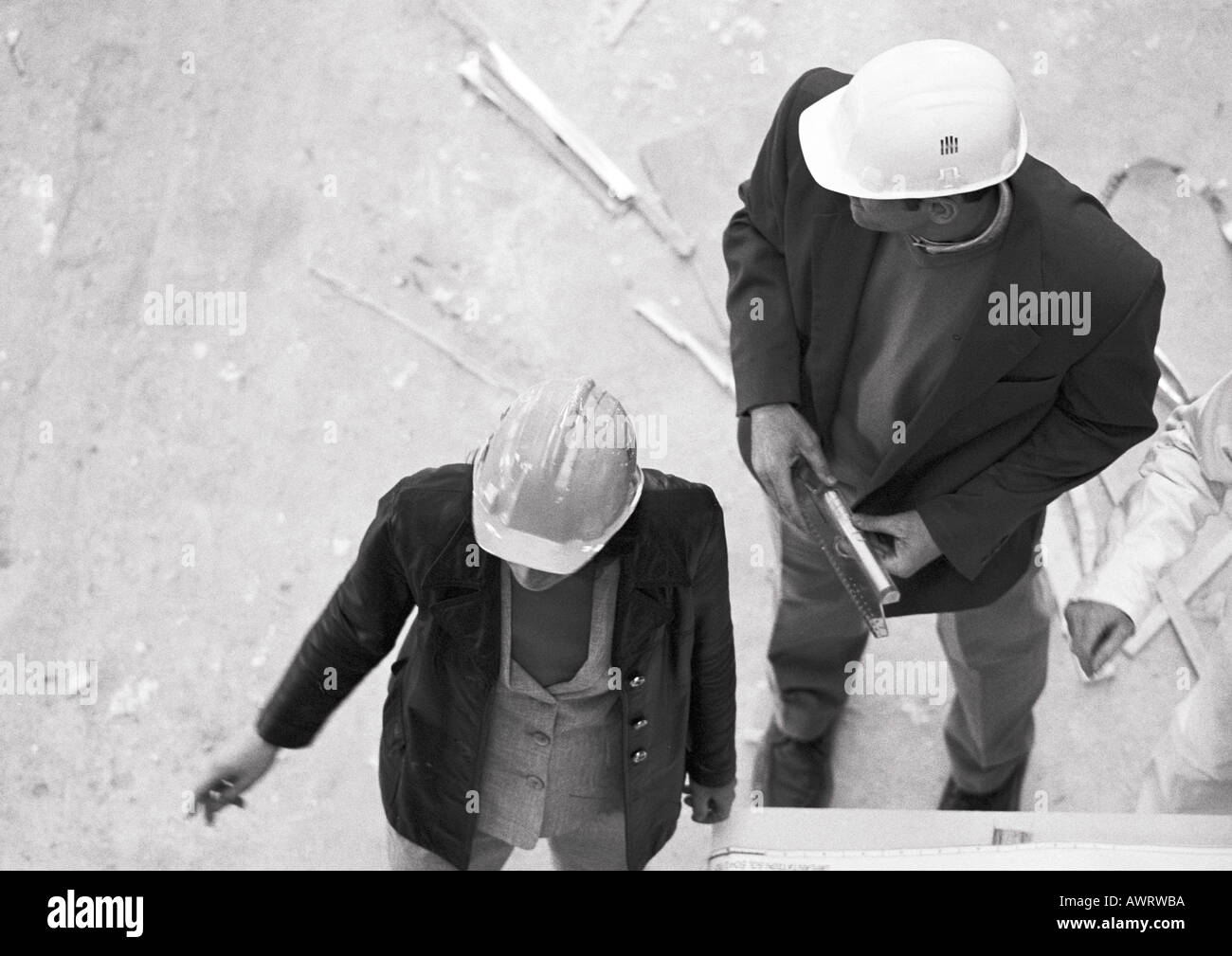Two people wearing hard hats, elevated view, b&w Stock Photo - Alamy
