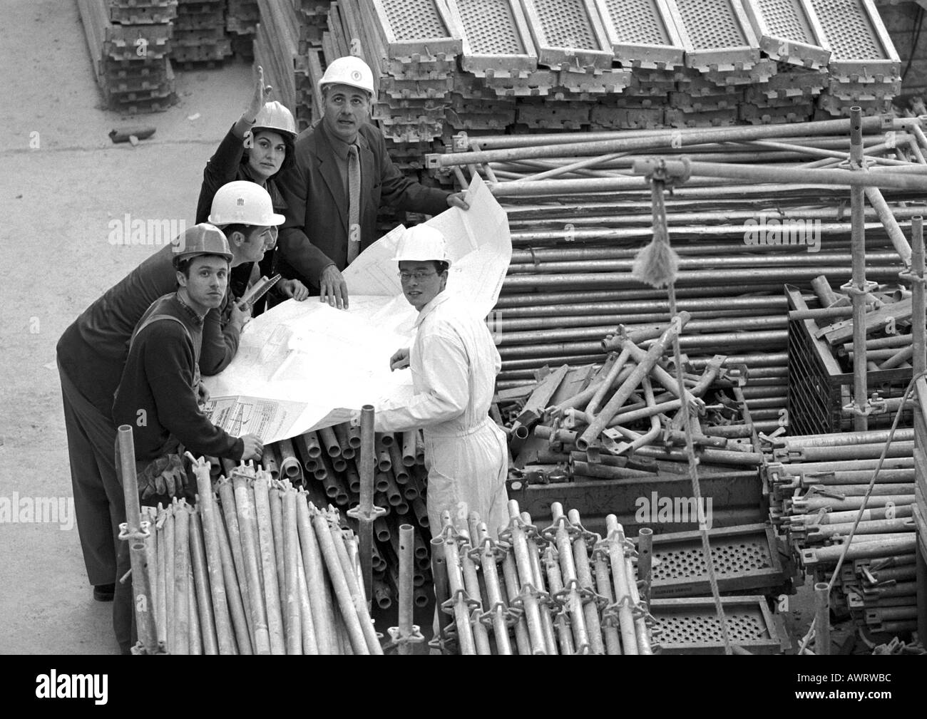 Five people examining blueprints in Black and White Stock Photos ...