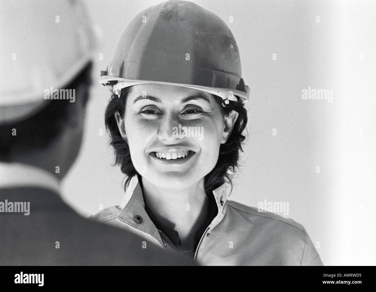 Woman wearing hard hat, smiling, close-up, b&w Stock Photo - Alamy