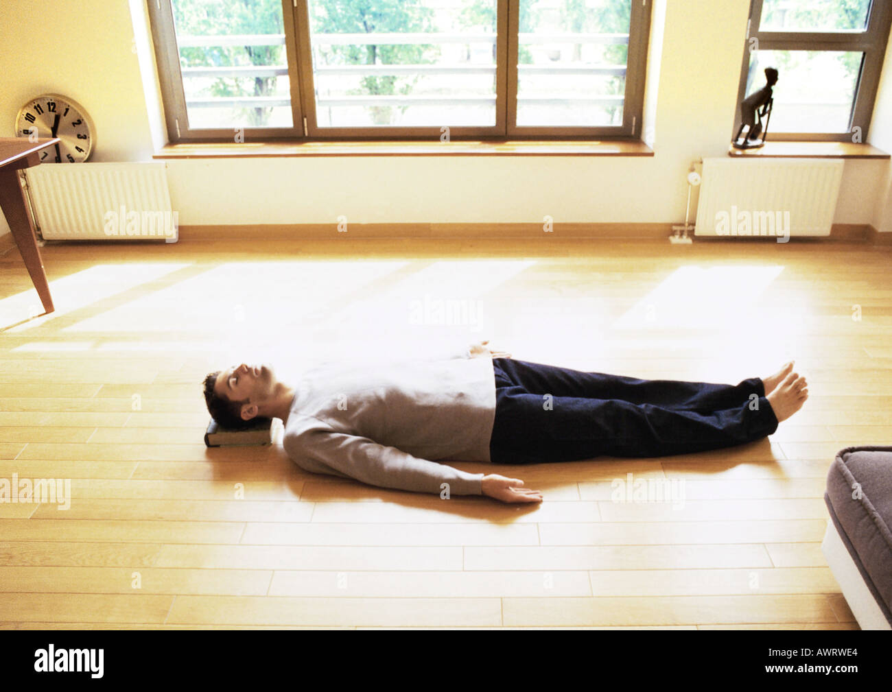 Man lying on floor Stock Photo - Alamy