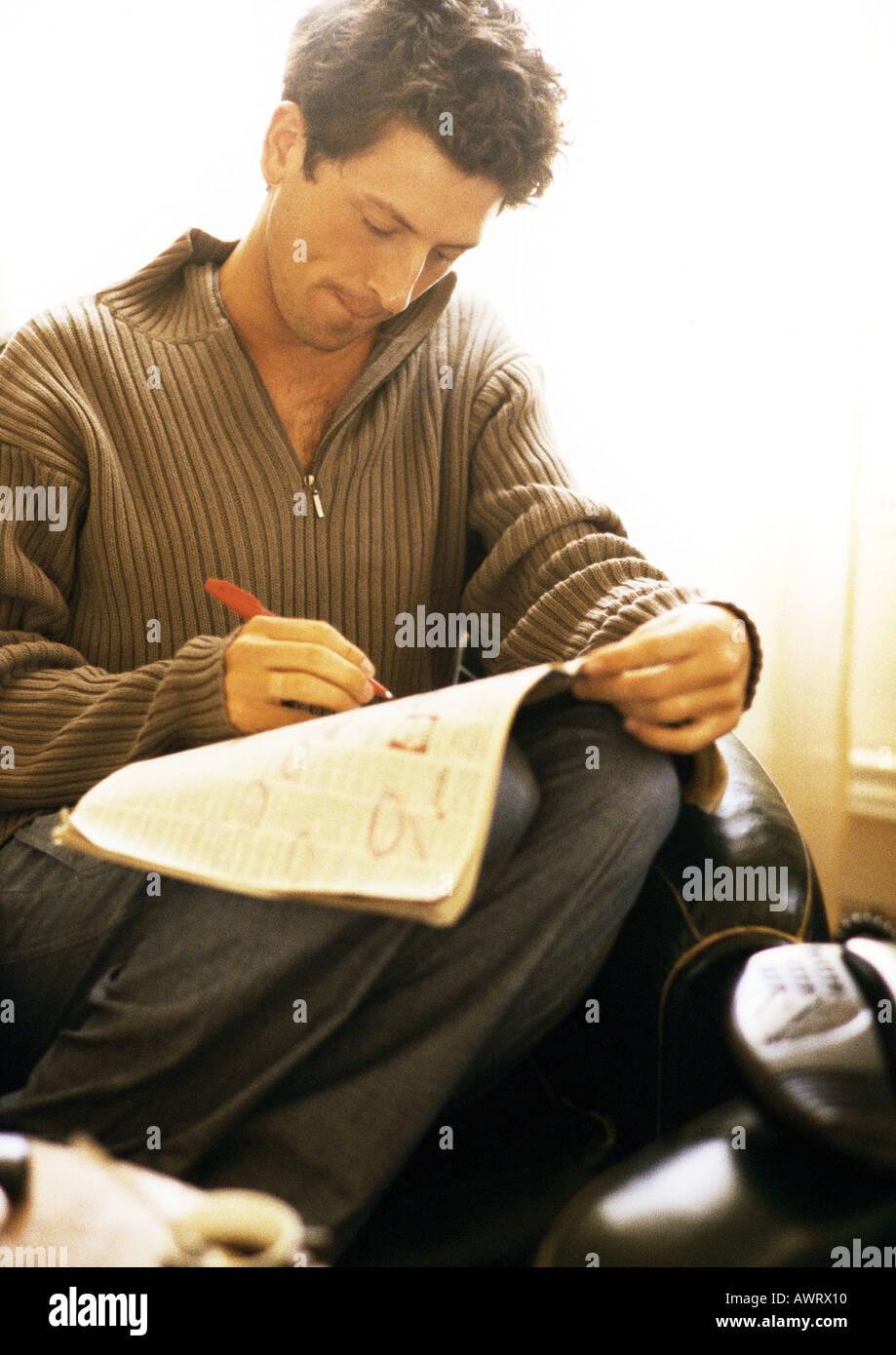 Man writing on newspaper Stock Photo - Alamy