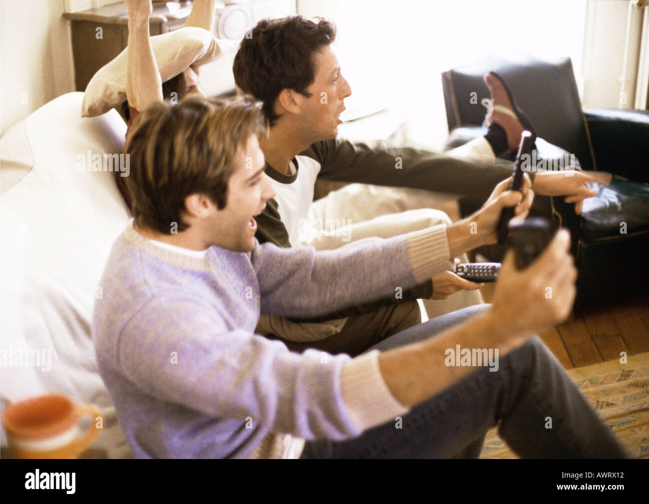 Three men on sofa excited High Resolution Stock Photography and Images ...
