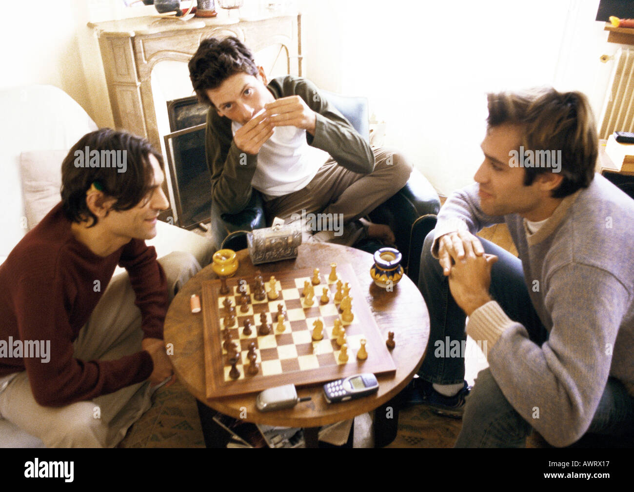 Three friends playing chess in hi-res stock photography and images - Alamy
