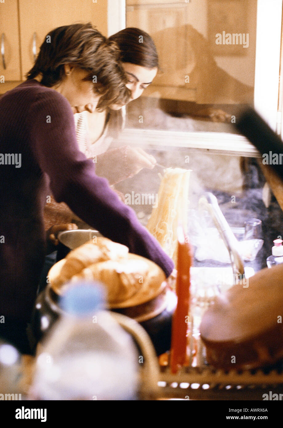Women preparing pasta in kitchen Stock Photo - Alamy