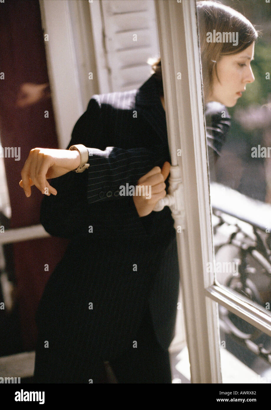 Woman looking out of window Stock Photo - Alamy