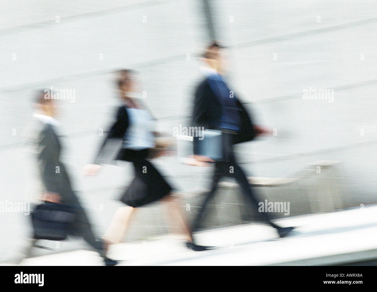 Business people walking in street, full length, tilt, blurred Stock ...