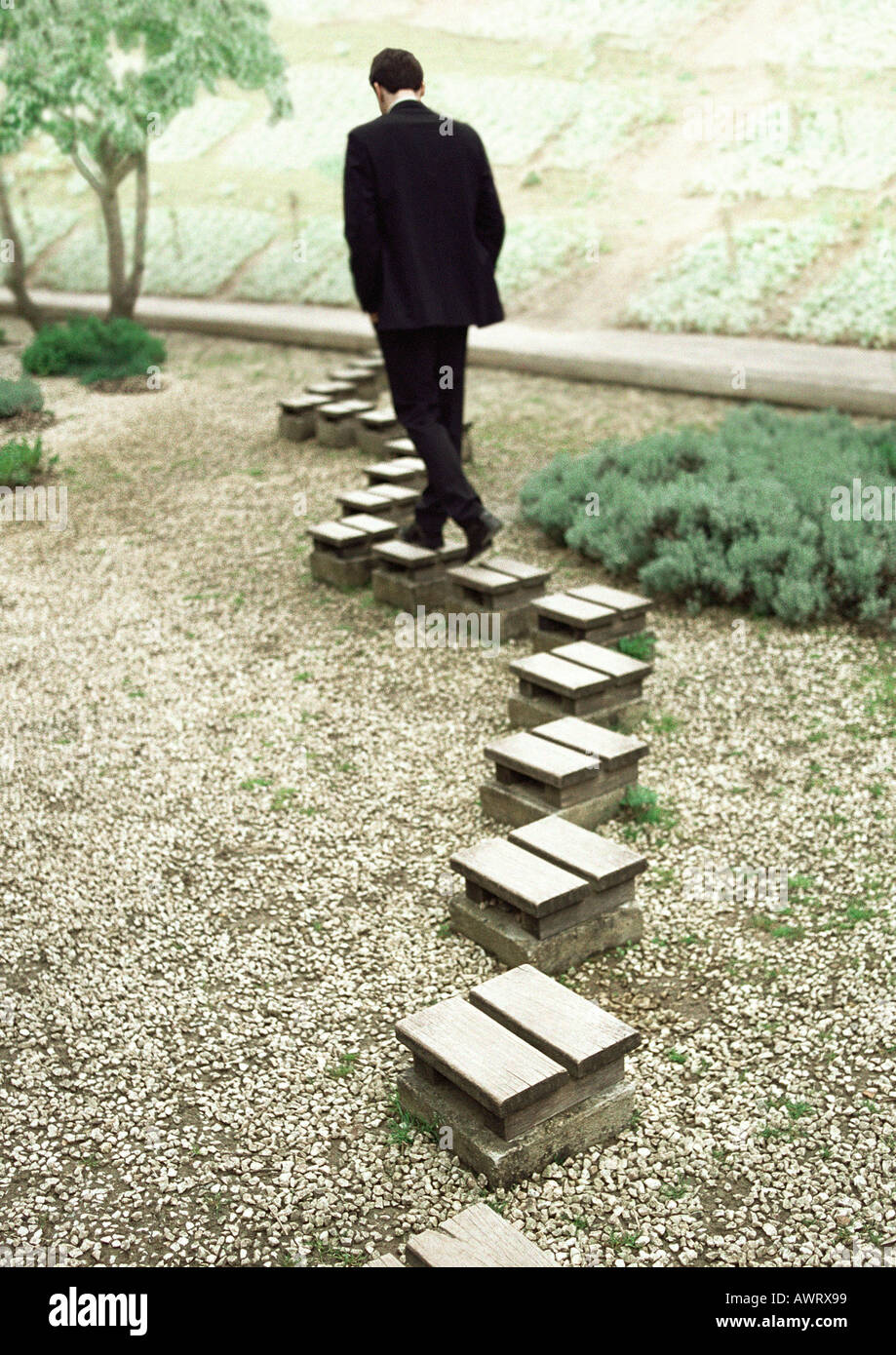 Man Walking On Stepping Stones
