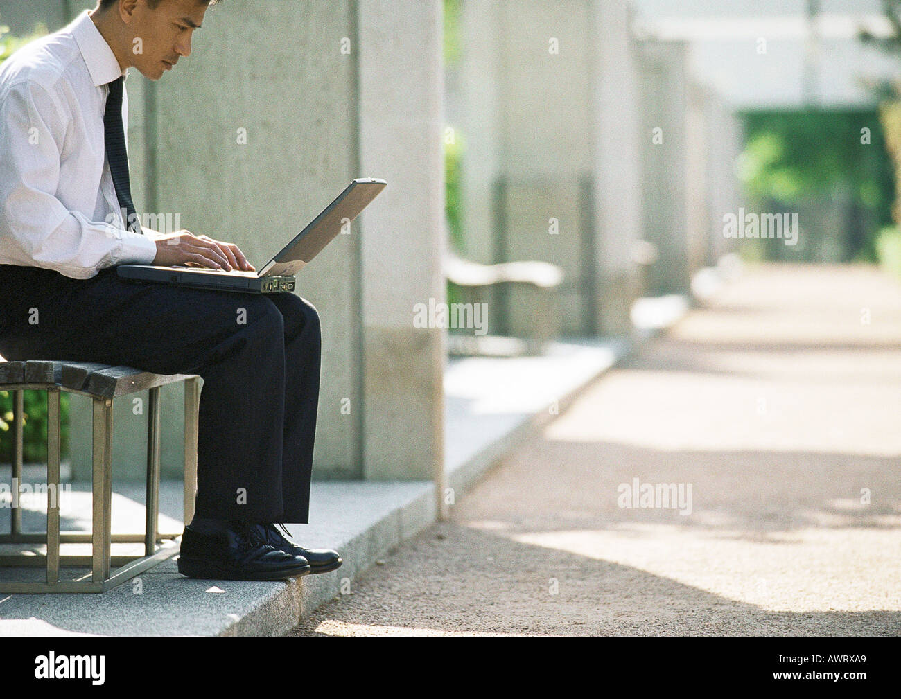 Businessman sits on bench works hi-res stock photography and images - Alamy