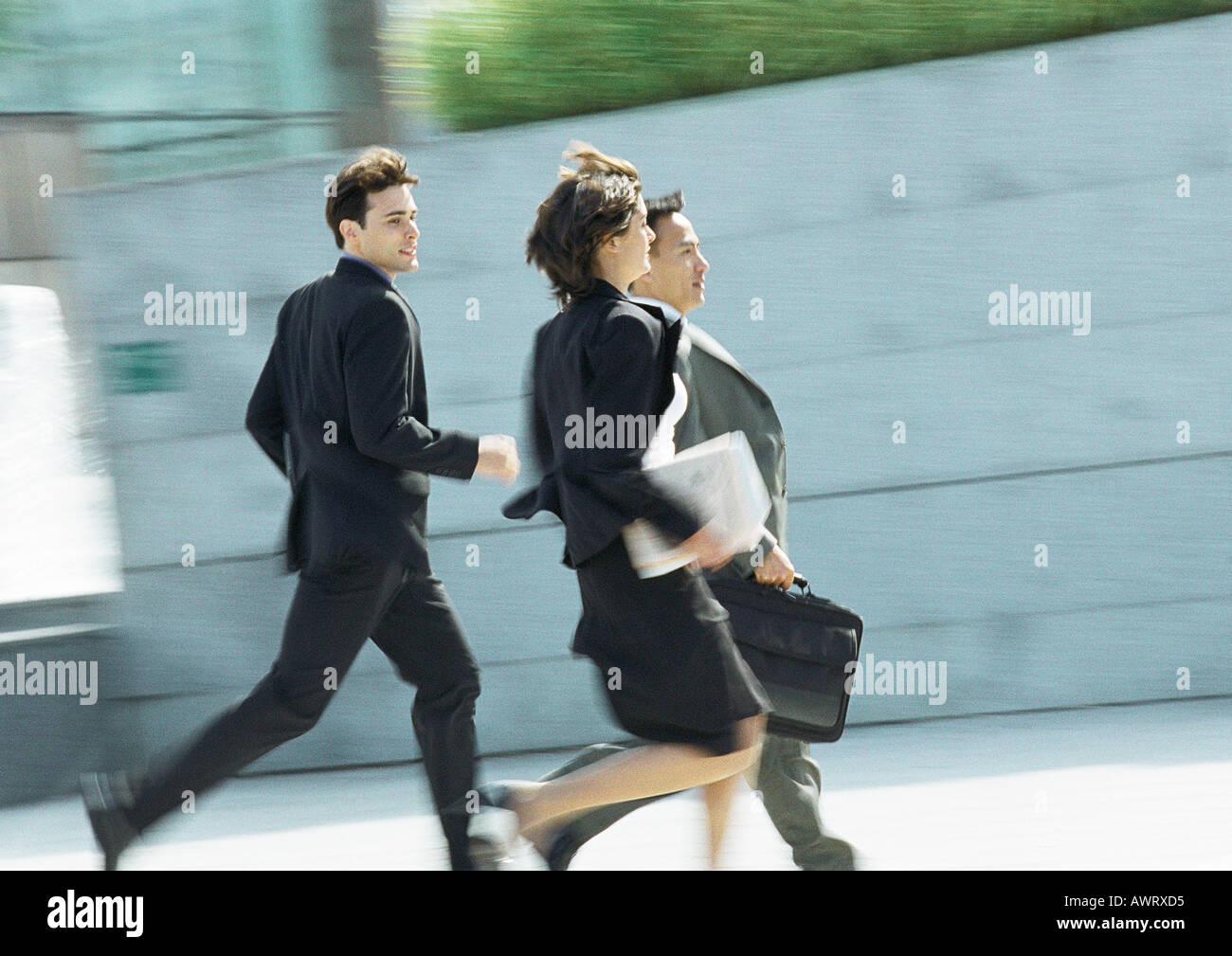Business people running outdoors, blurred motion Stock Photo - Alamy