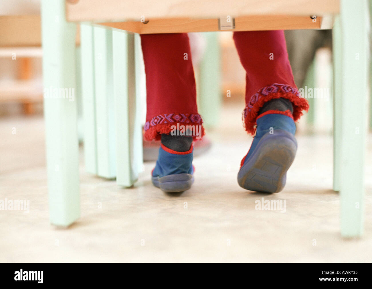 Child sitting in classroom, low section Stock Photo - Alamy