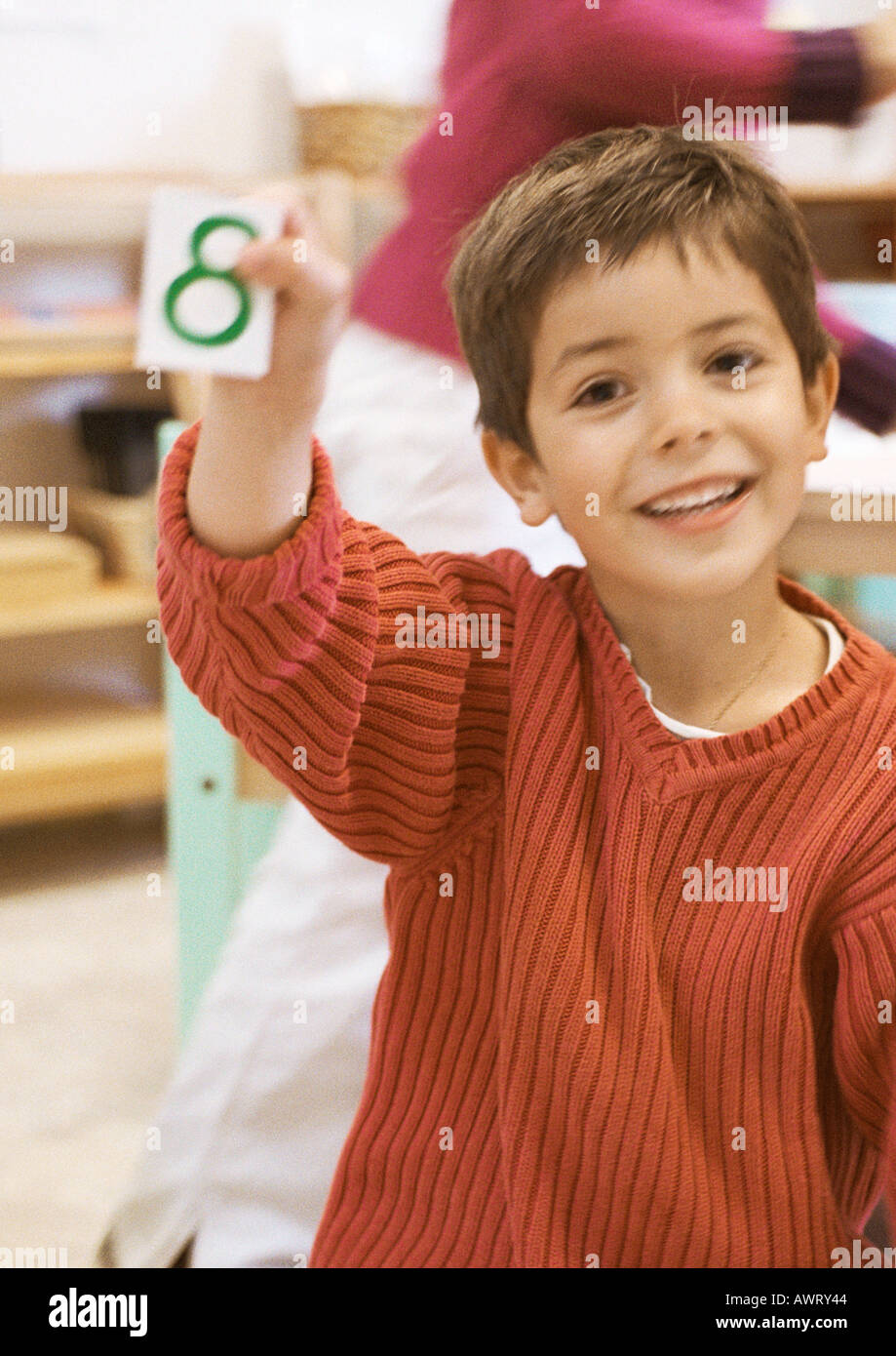 Child holding card, smiling Stock Photo - Alamy