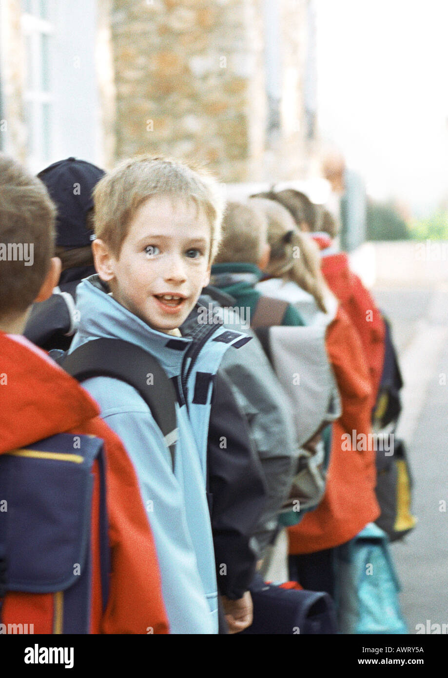 Children in single file, one looking back, portrait Stock Photo - Alamy