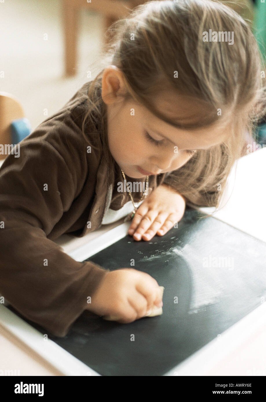 Girl erasing blackboard hi-res stock photography and images - Alamy