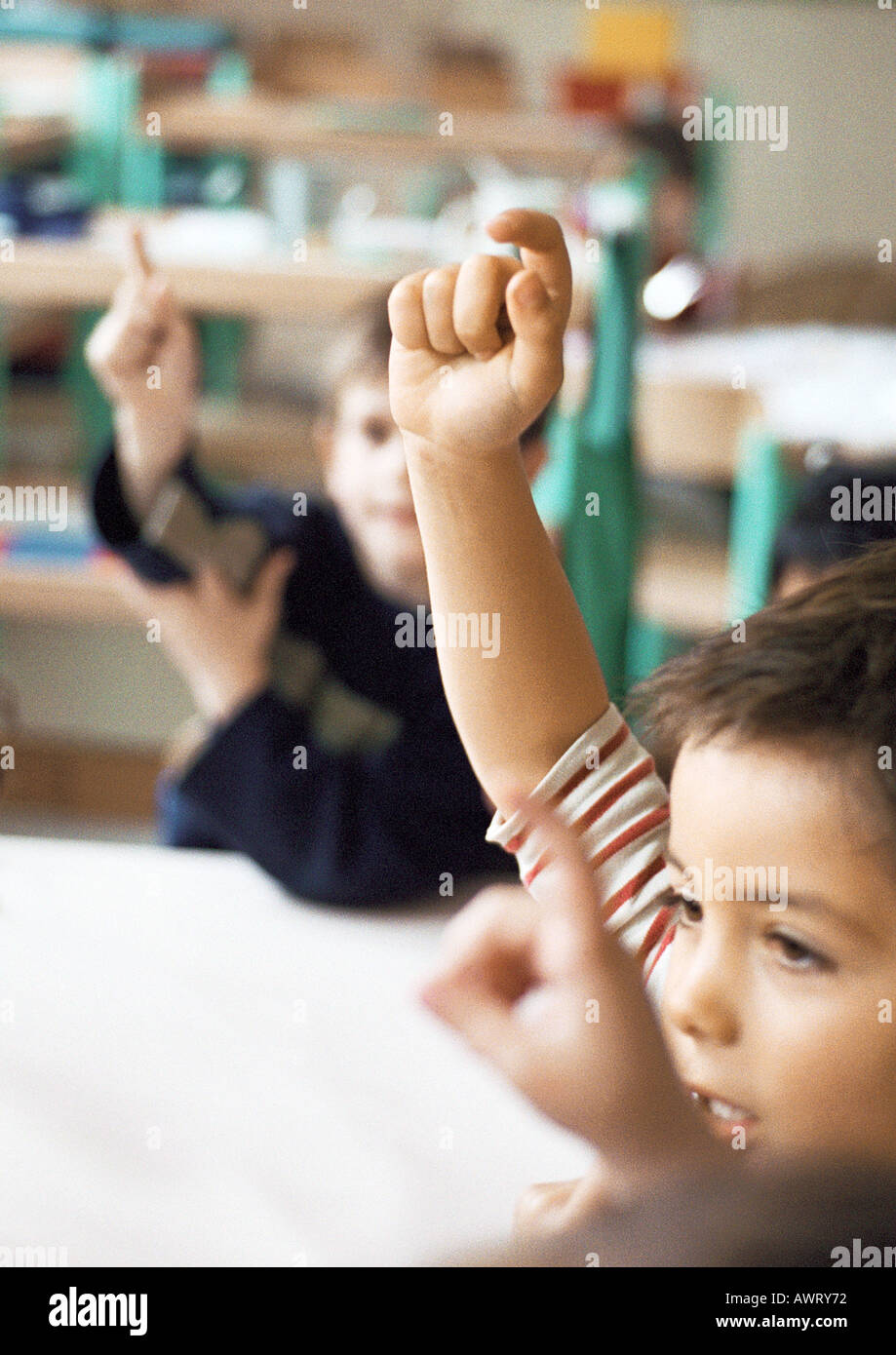 Children raising hands, close-up, blurred Stock Photo - Alamy