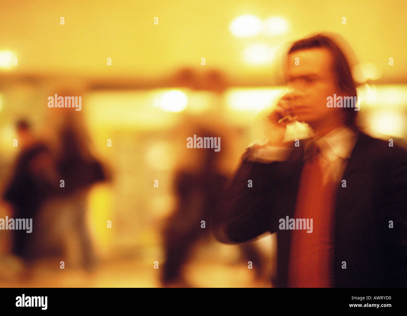 Businessman using cell phone, blurred Stock Photo - Alamy