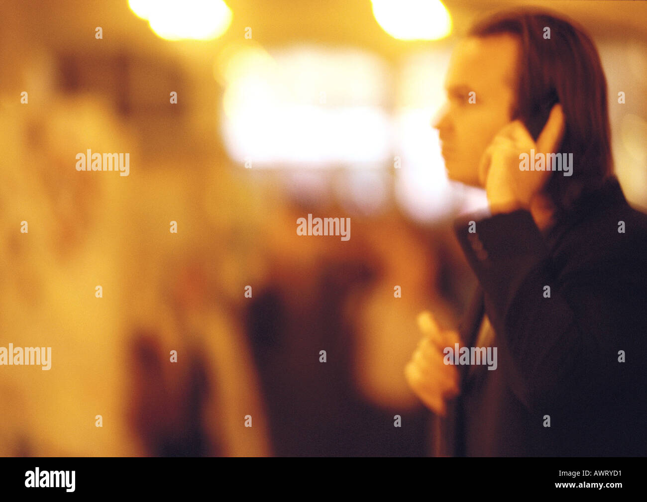 Businessman using cell phone, side view, blurred Stock Photo - Alamy